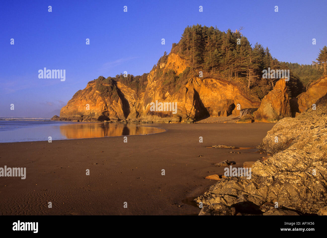Sunset colors the bluffs at Hug Point State Recreation Area on the ...