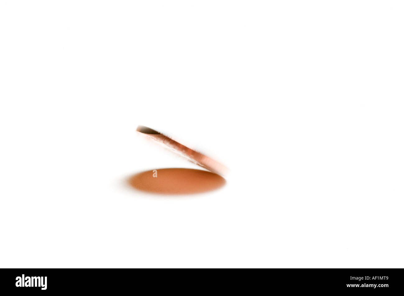 copper coin spinning on a white background Stock Photo - Alamy