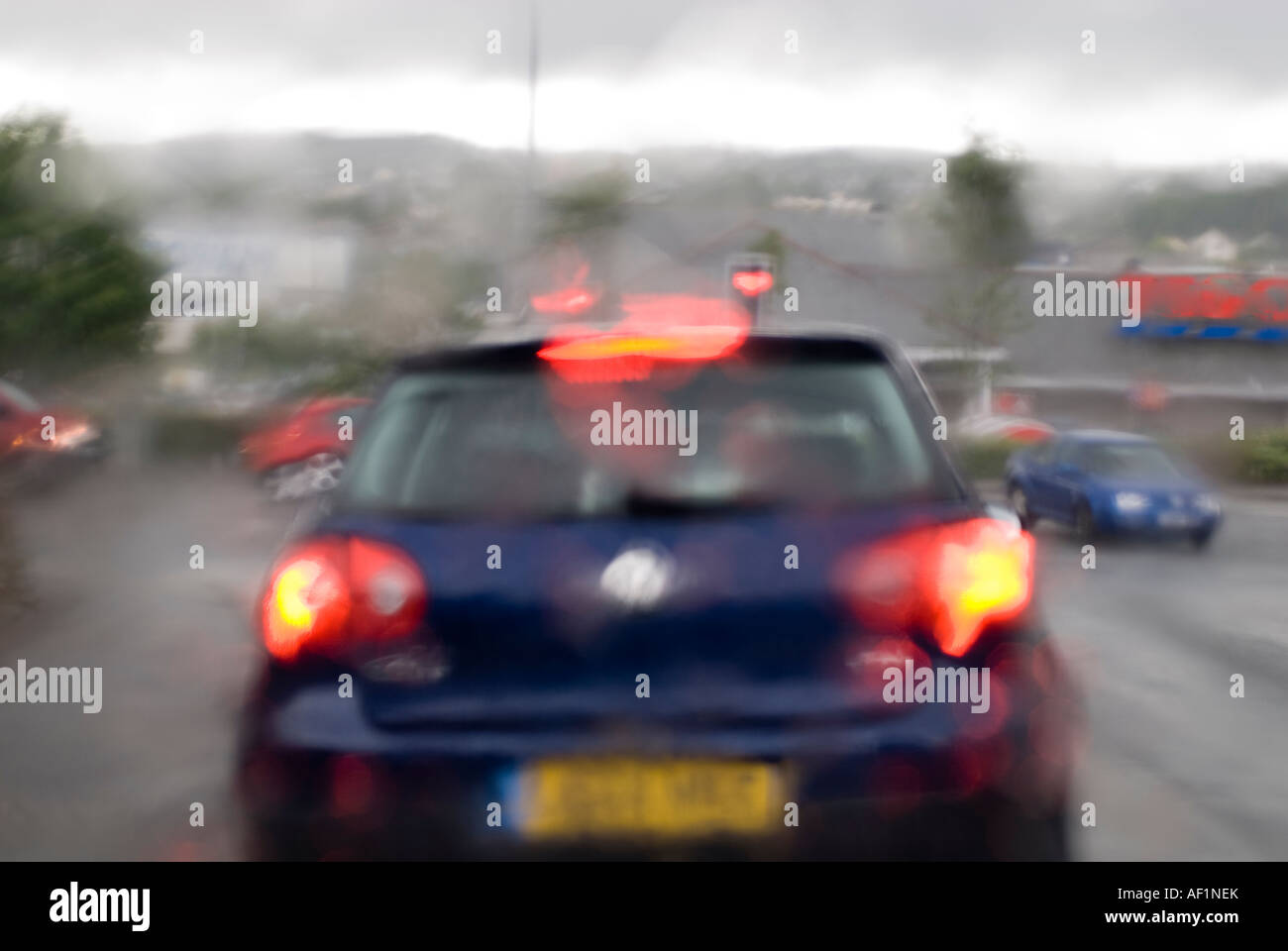 Cars waiting at traffic lights in the rain....Holmbush, Cornwall, 2007 ...