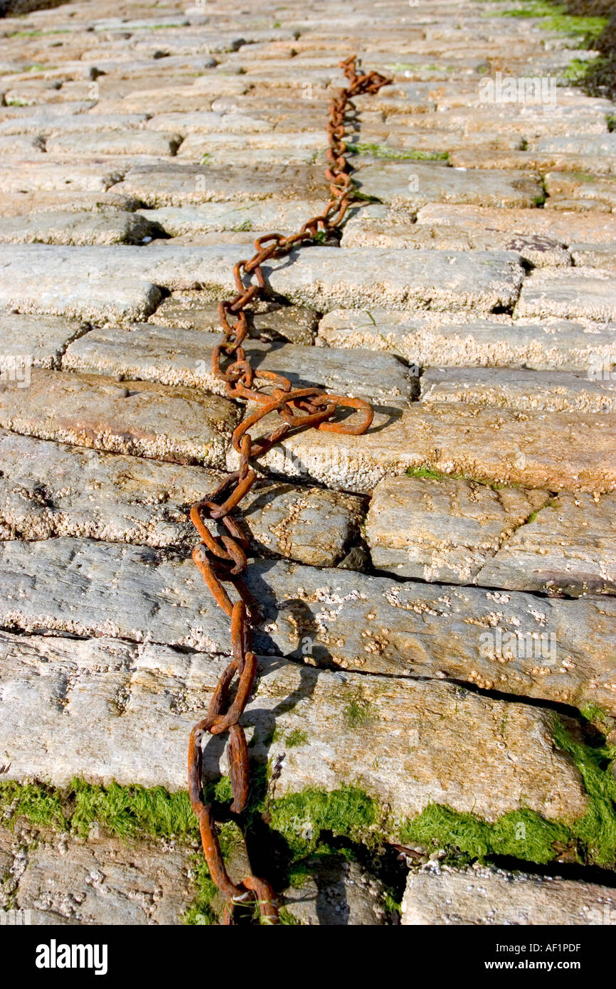 abandoned chains on rocks of pier Stock Photo - Alamy