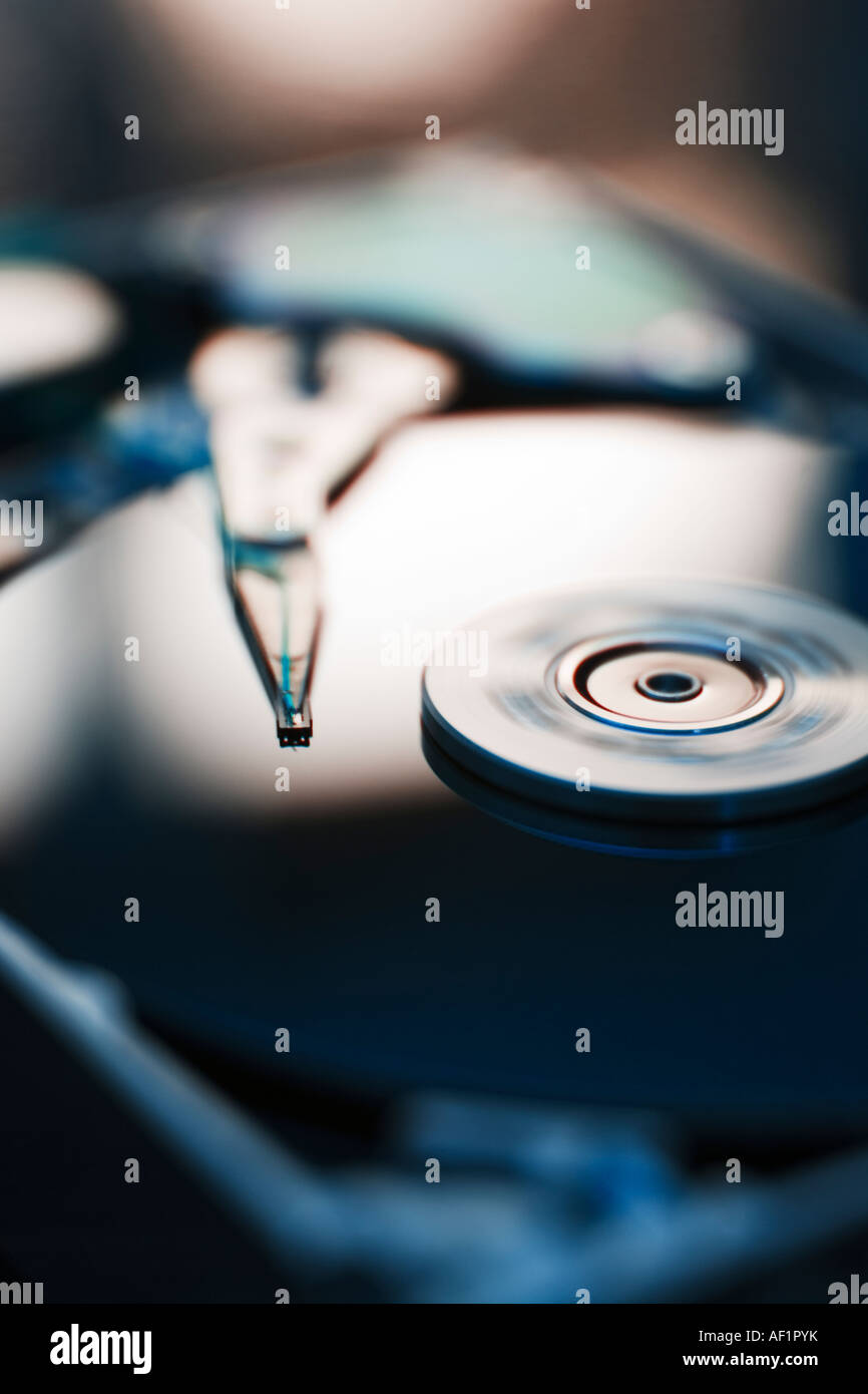 Spinning computer hard drive disc and arm Stock Photo - Alamy