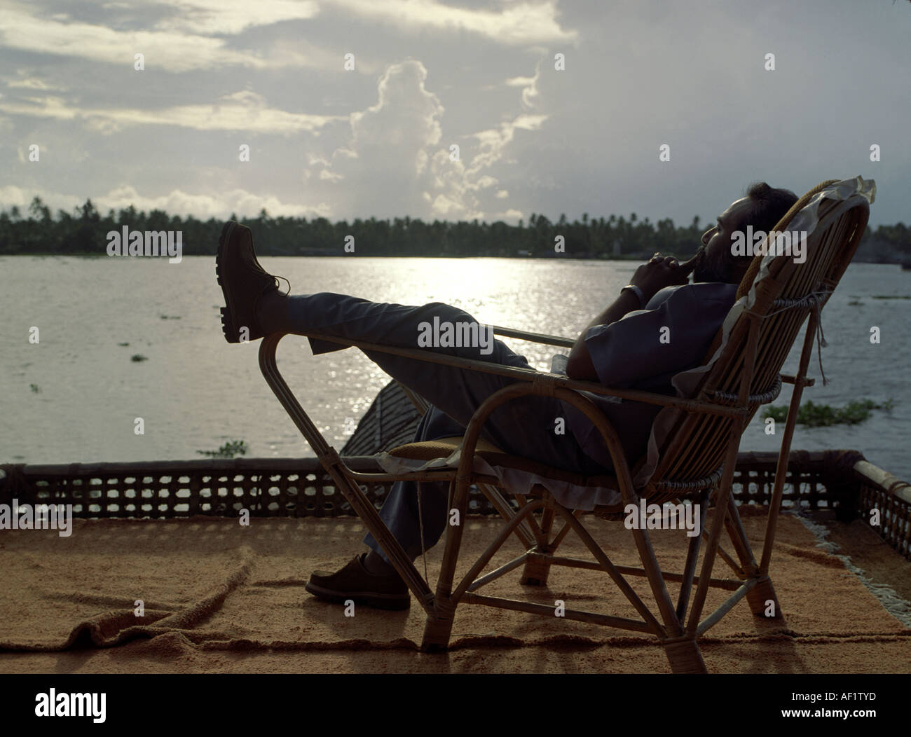 TOURIST RESTING ON THE DECK OF HOUSE BOAT IN KERALA Stock Photo - Alamy