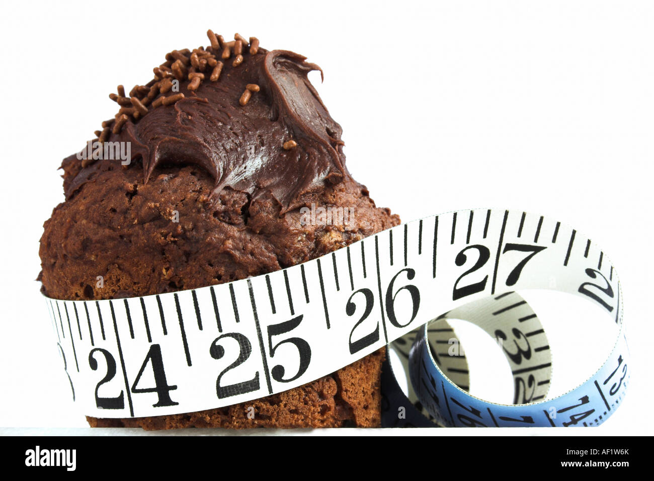 Horizontal colour picture of a chocolate cake with a measuring tape ...