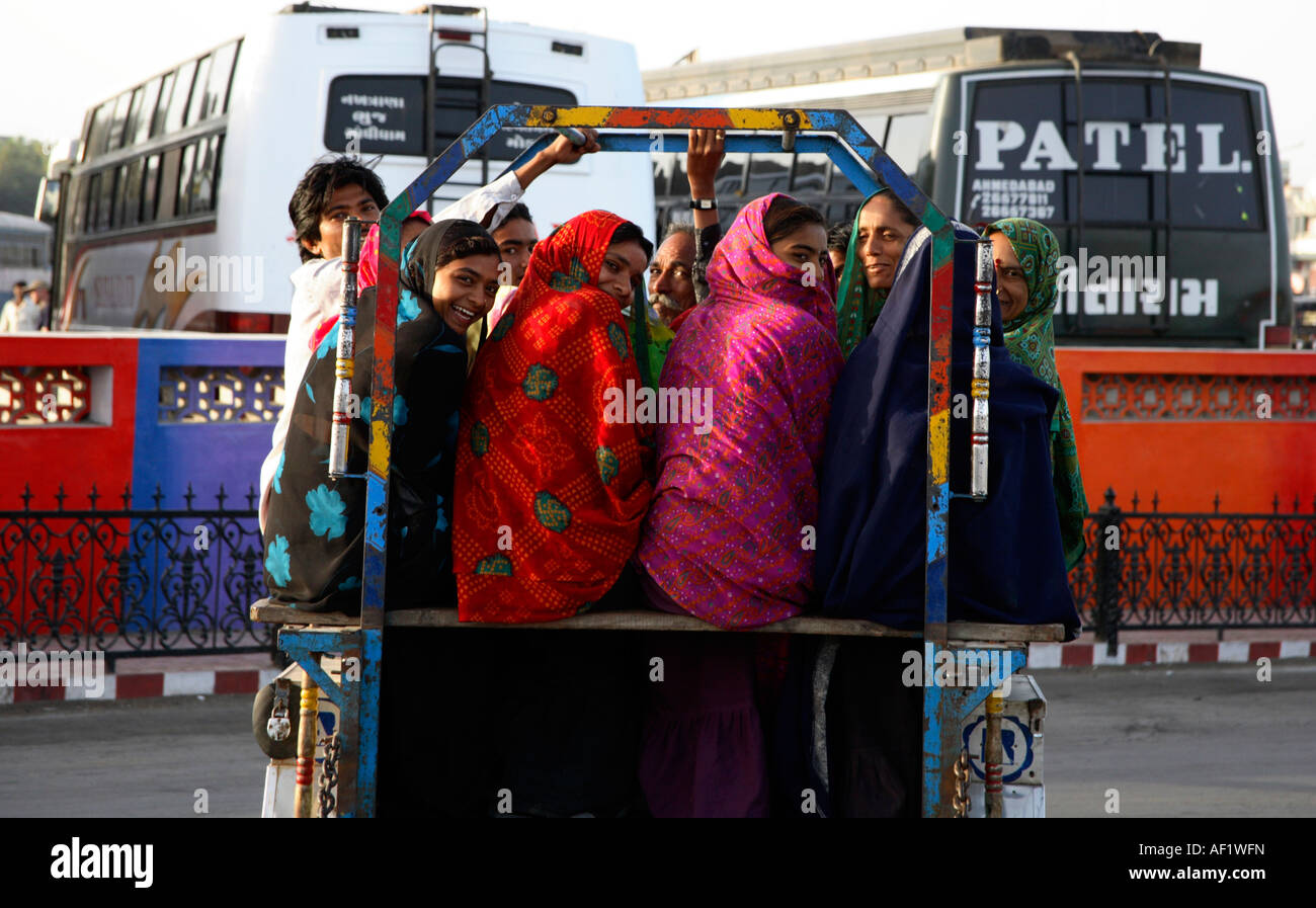 Indian females going to work in rear of chakda - motorbike rickshaw ...