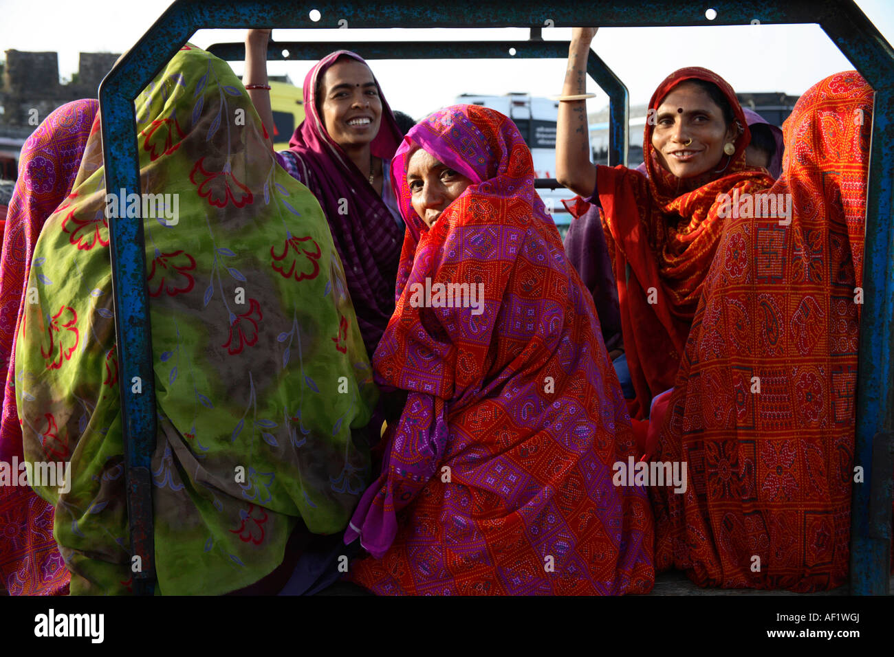 Indian females going to work in rear of chakda - motorbike rickshaw ...
