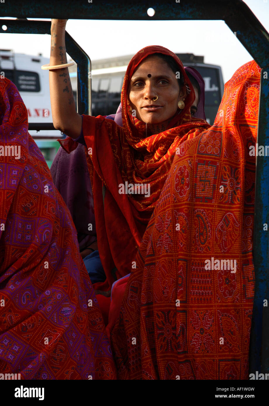 Indian females going to work in rear of chakda - motorbike rickshaw ...
