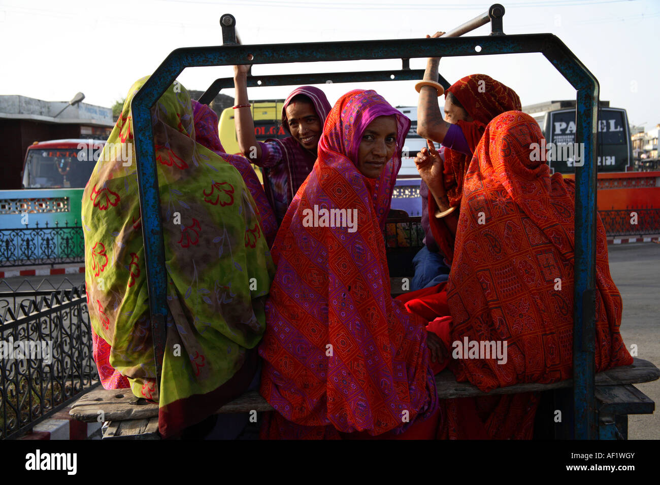 Indian females going to work in rear of chakda - motorbike rickshaw ...