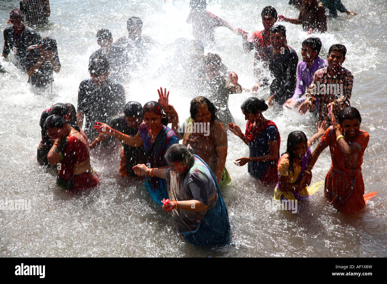 Indian families splashing water celebrating Holi Spring Festival at ...