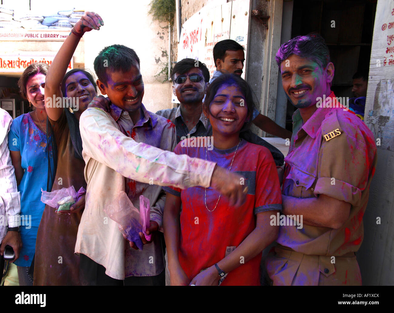 Indian males and females celebrating Holi Spring Festival with Temple ...