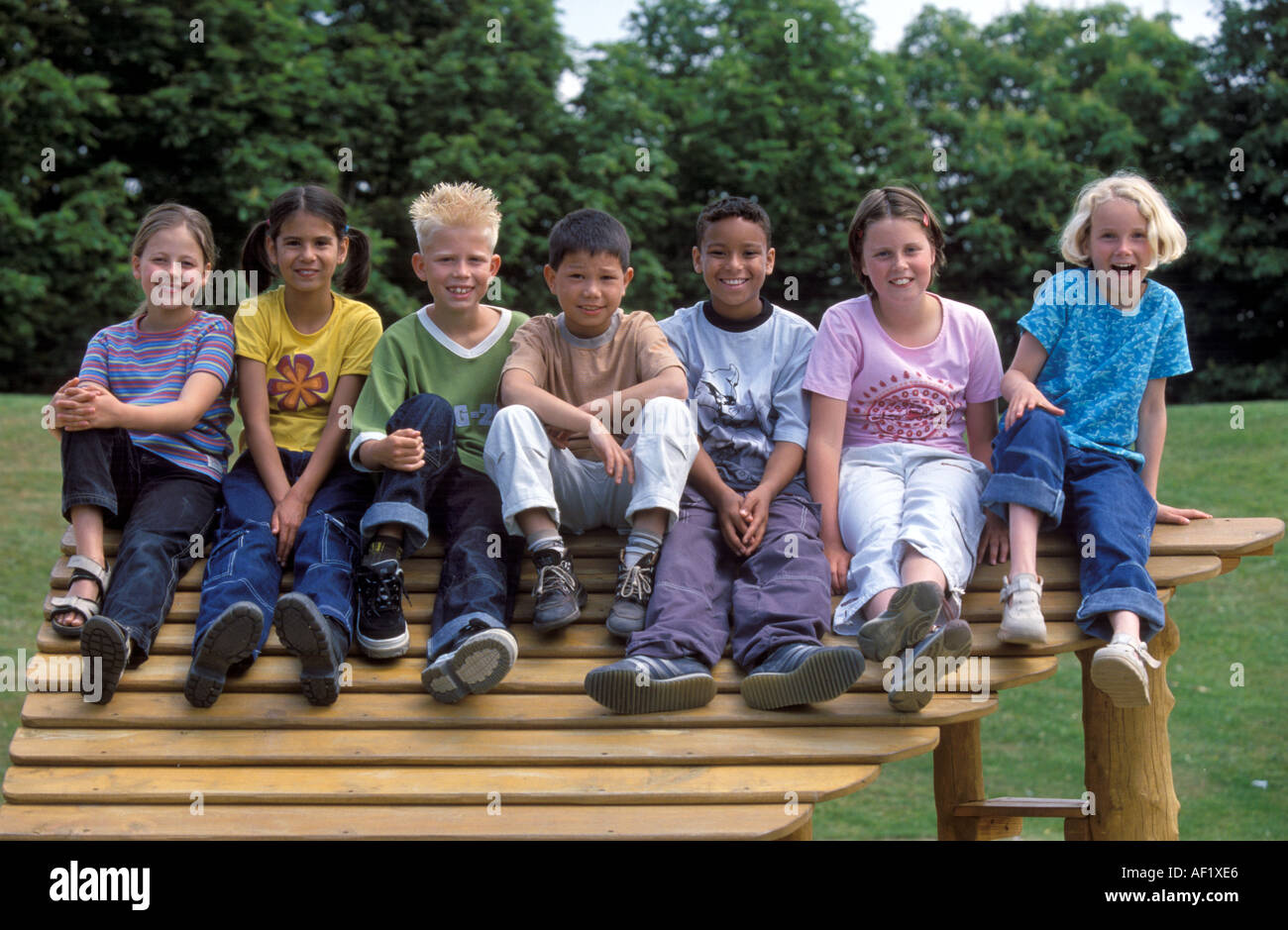 Group of seven children sitting together Stock Photo - Alamy