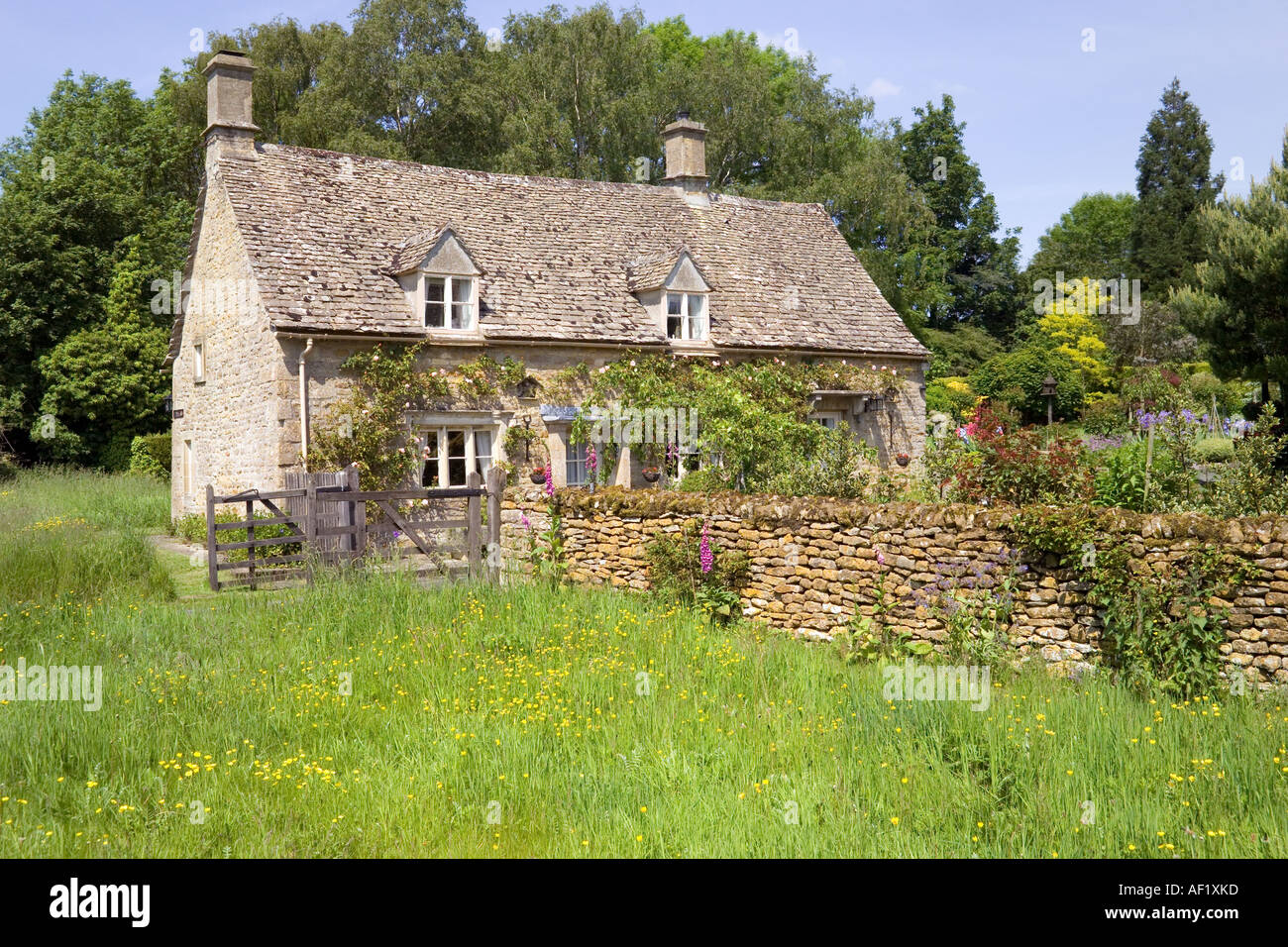 Cottage on the village green in the Cotswold village of Wyck Rissington ...