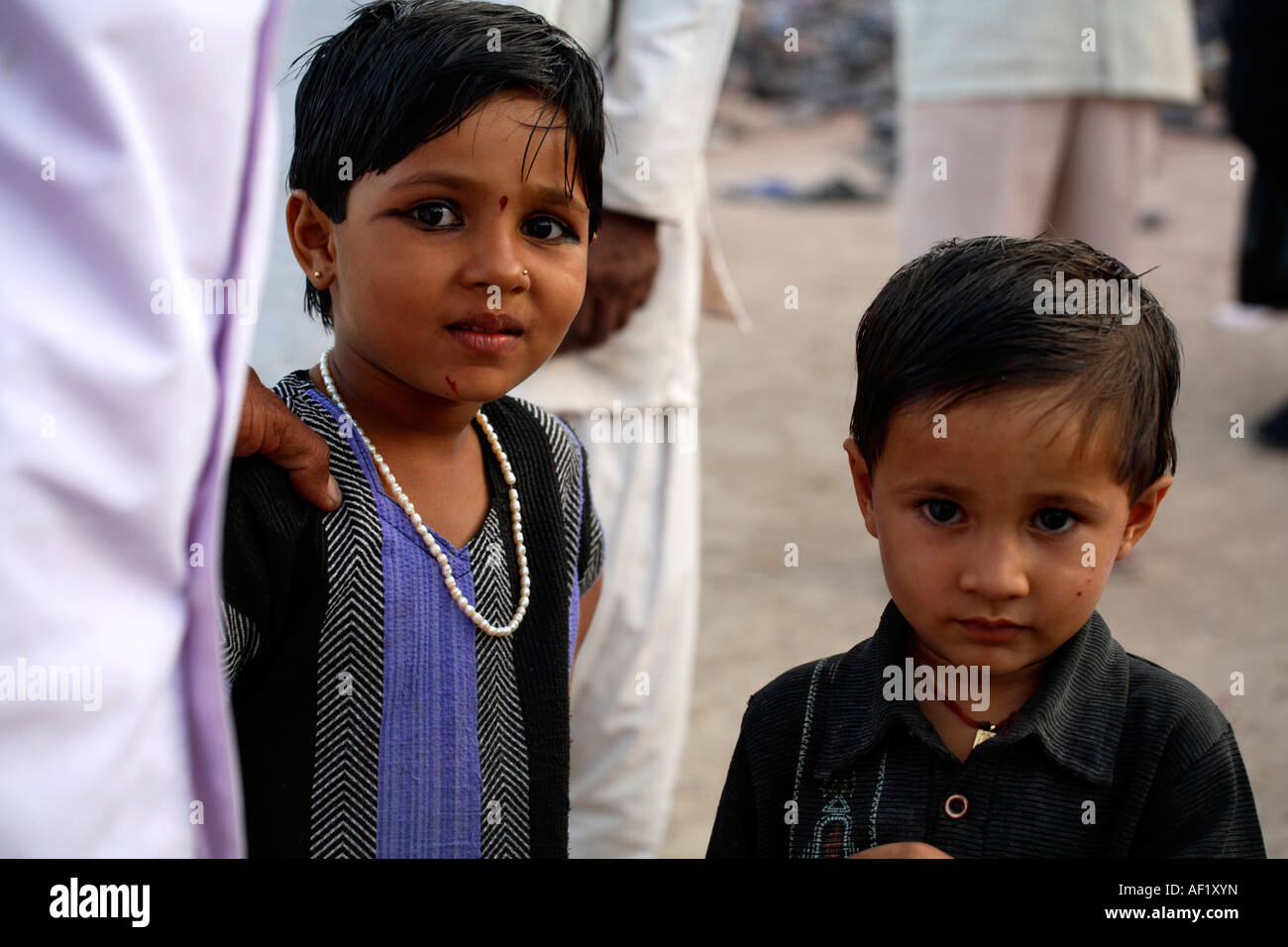 Well groomed young Indian boy and girl posing outside Dwarkadhish ...