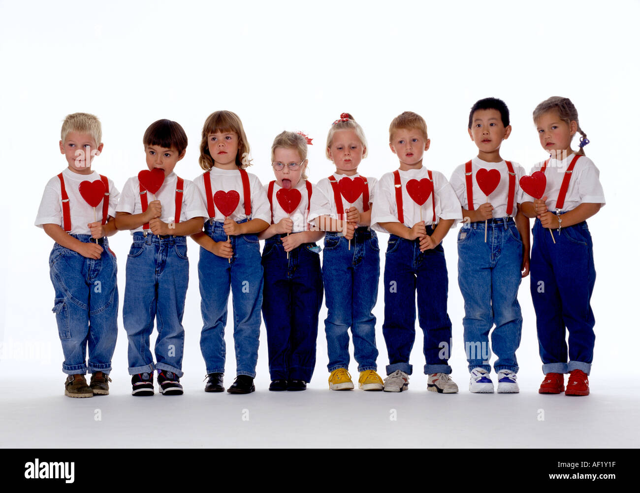 Eight children with red heart shaped lollies Stock Photo - Alamy