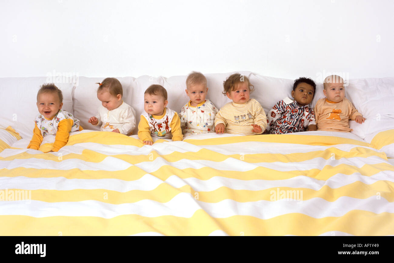 Seven babies in a bed Stock Photo - Alamy