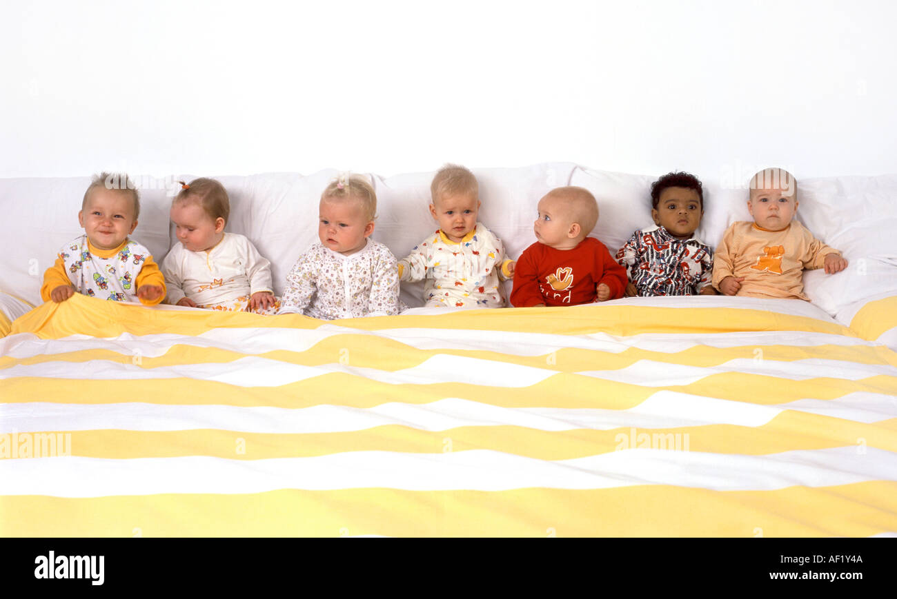 Seven babies in a bed Stock Photo - Alamy
