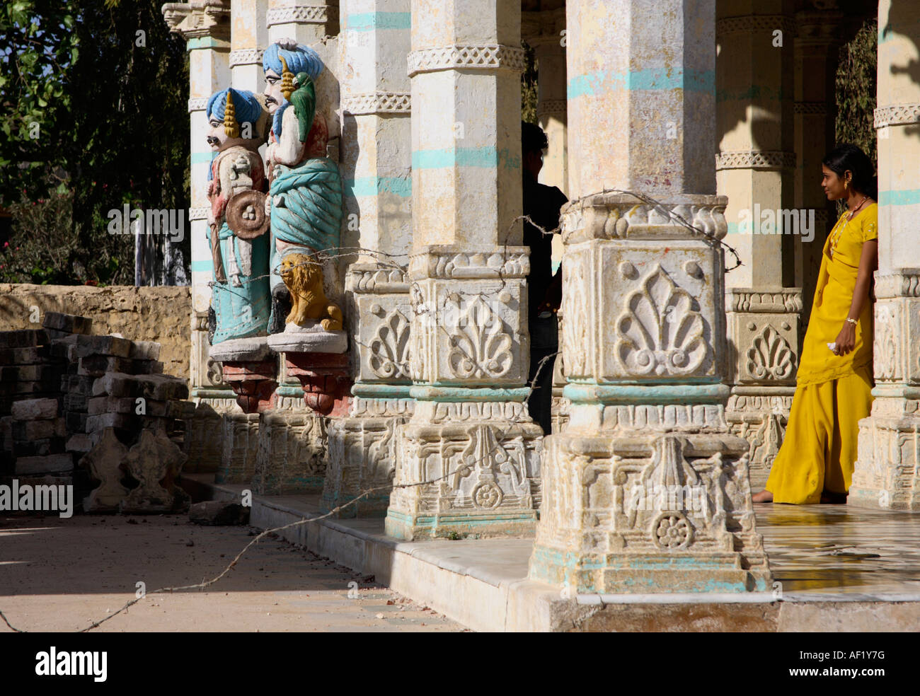 Indian woman walks through ruins of beachside Temple complex, Porbandar ...