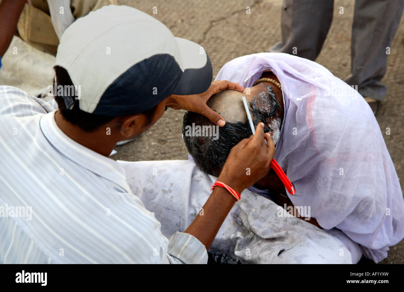 Indian male receiving mundan - head shaved as mark of respect during ...