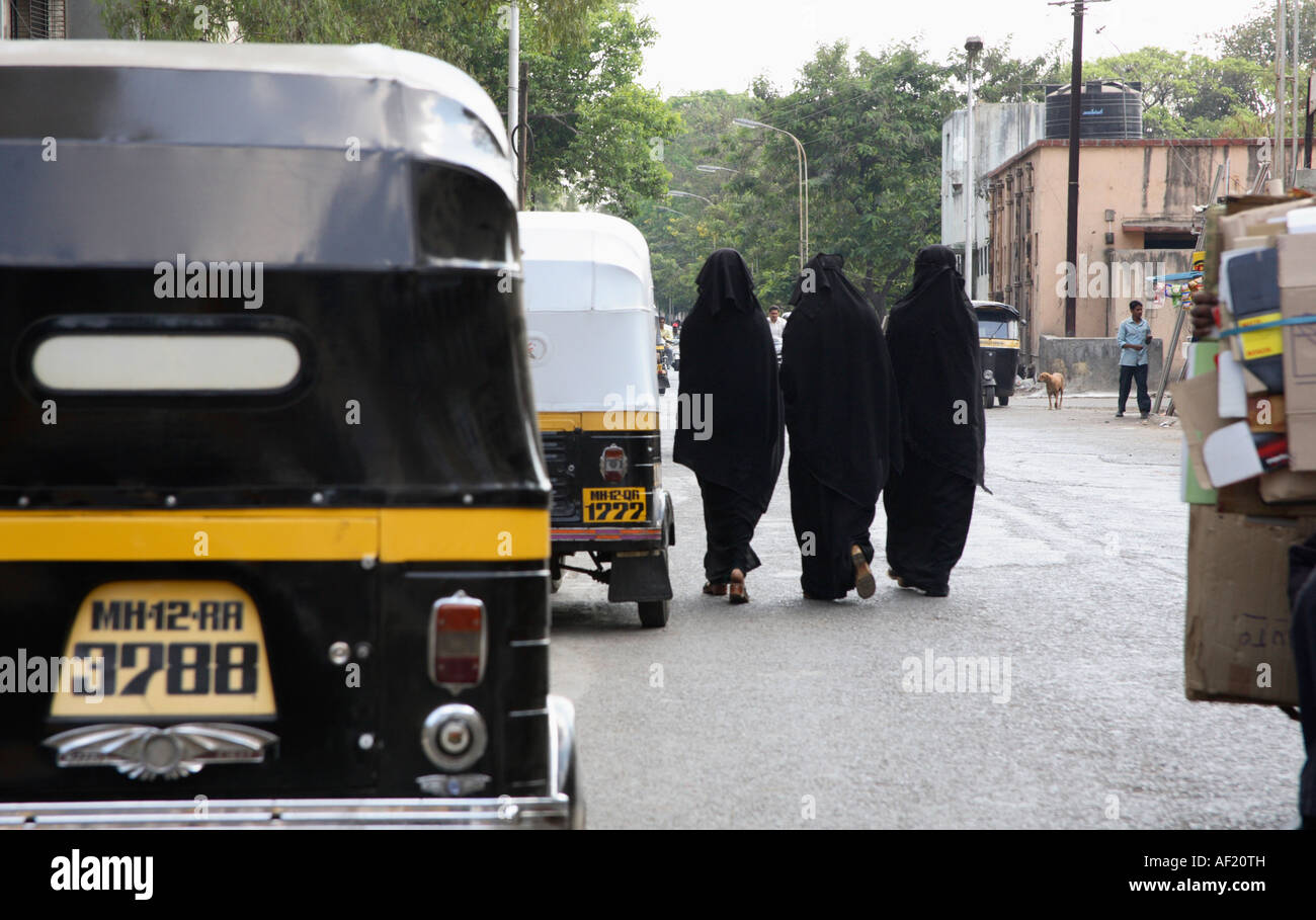 Three Indain muslim women wearing niqab walking along street, Pune ...