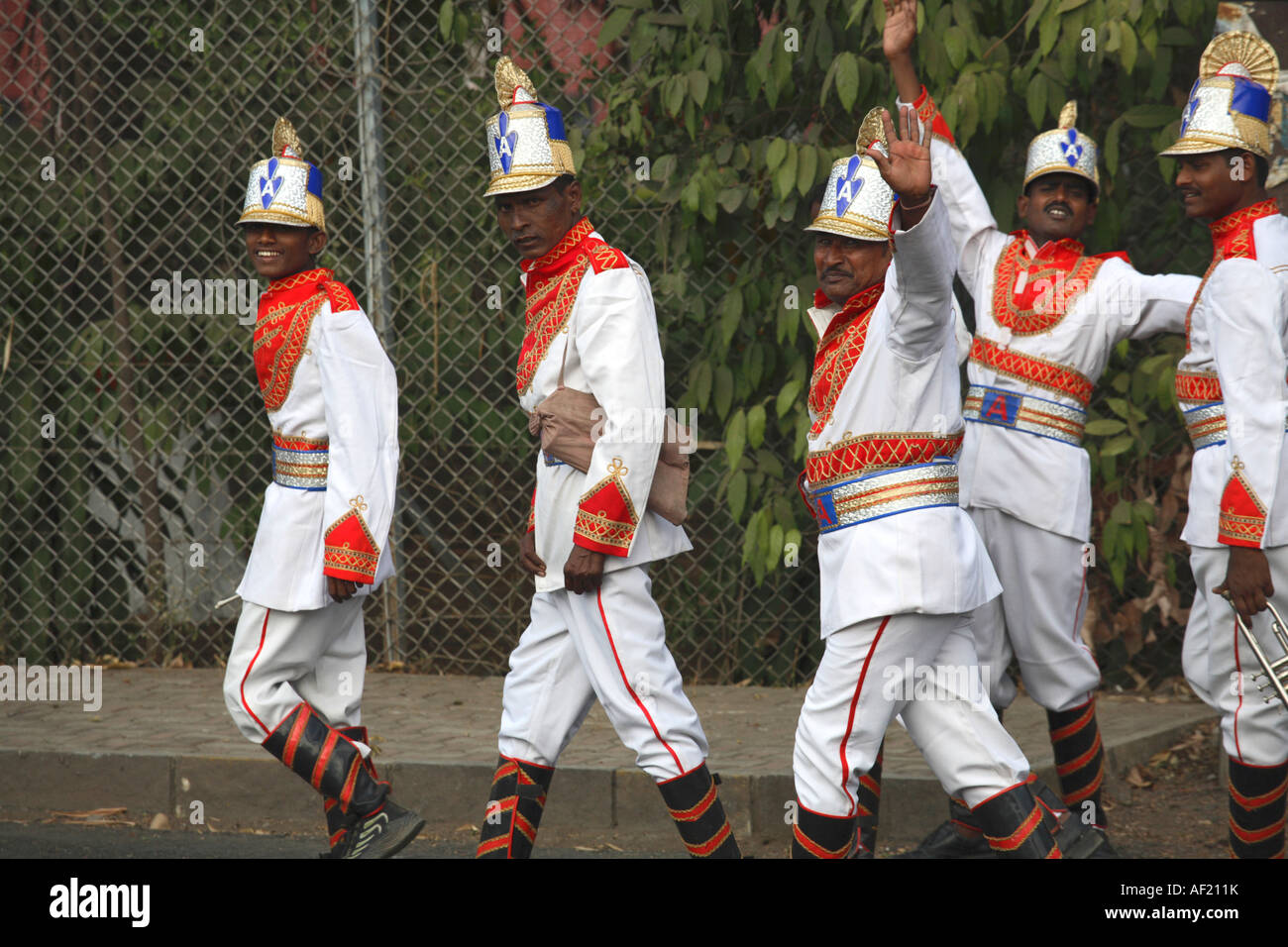Indian musicians dressed in their garish band uniform walking through ...