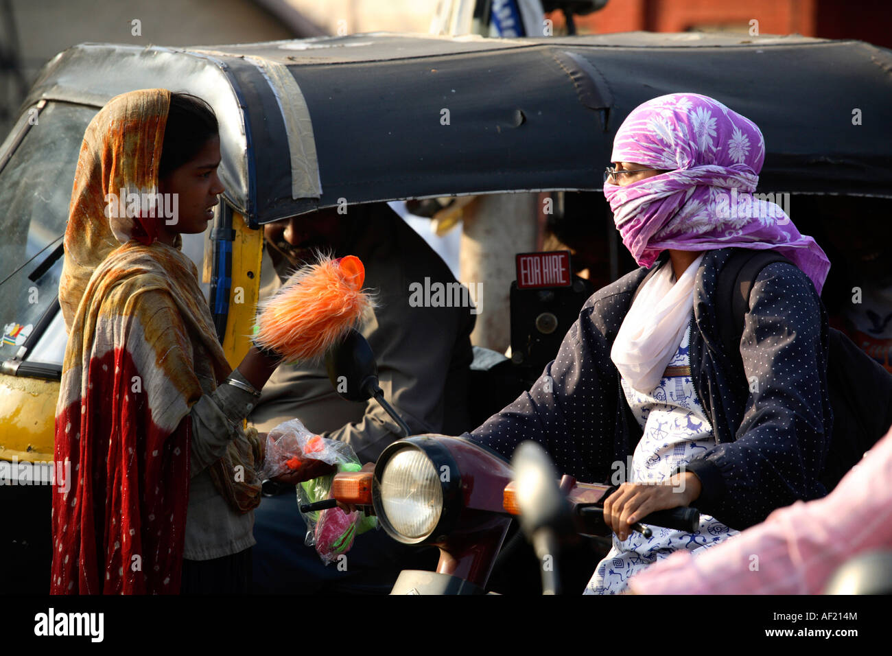 Young Indian girl selling glove puppet in busy traffic, Pune, India ...
