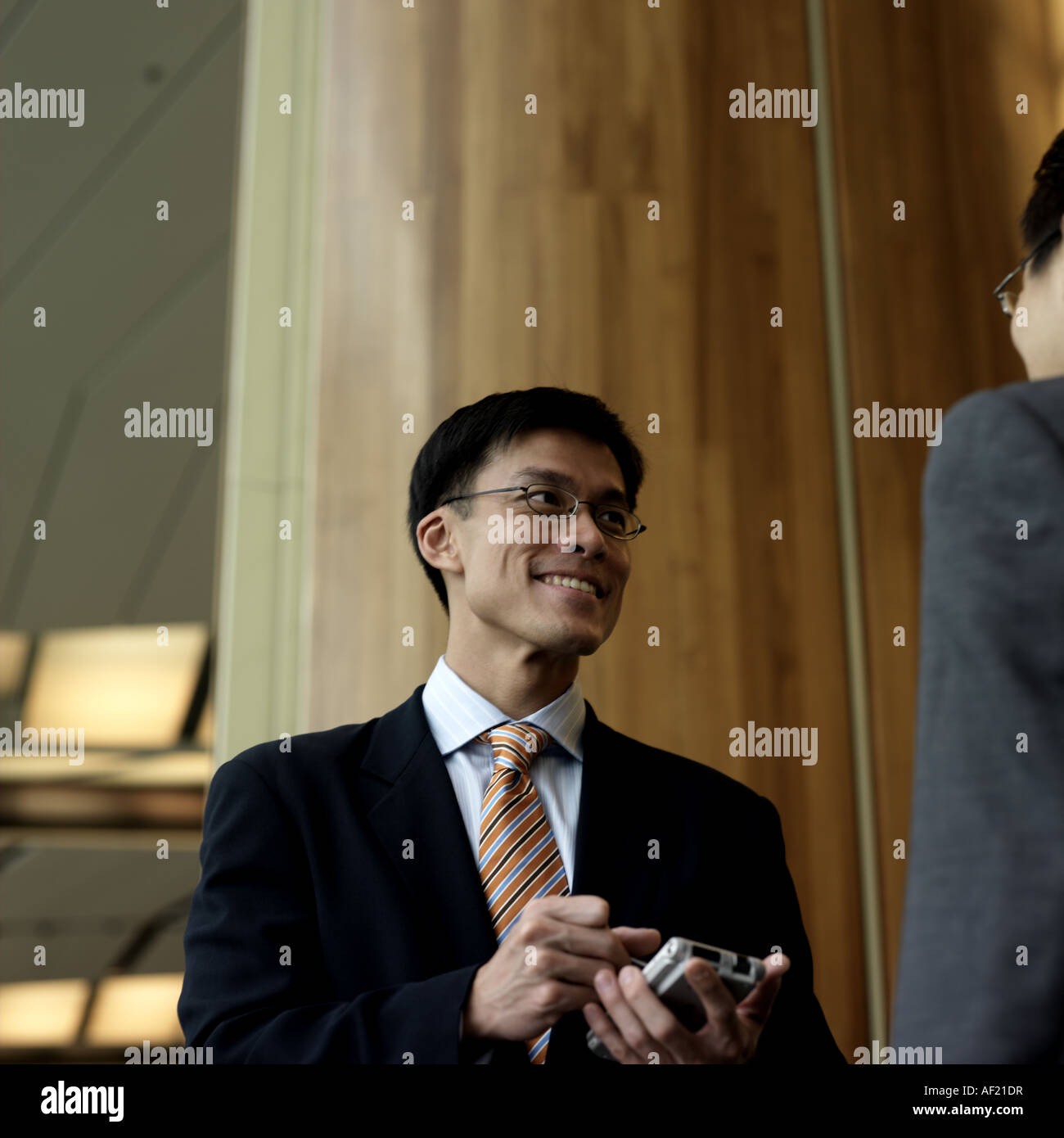 Businessmen talking, over the shoulder view Stock Photo - Alamy