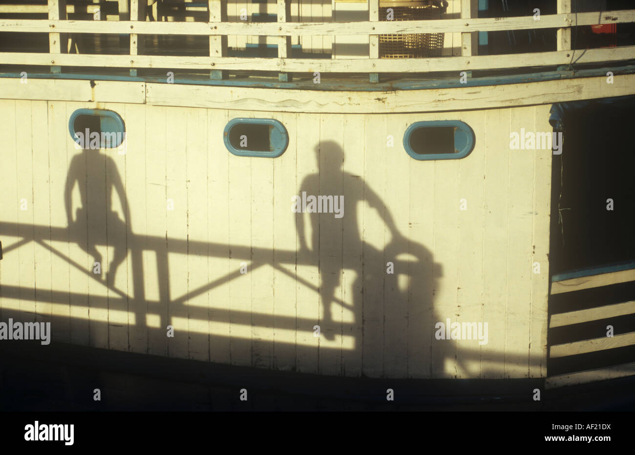 Shadows of people fall on an amazon boat Stock Photo - Alamy