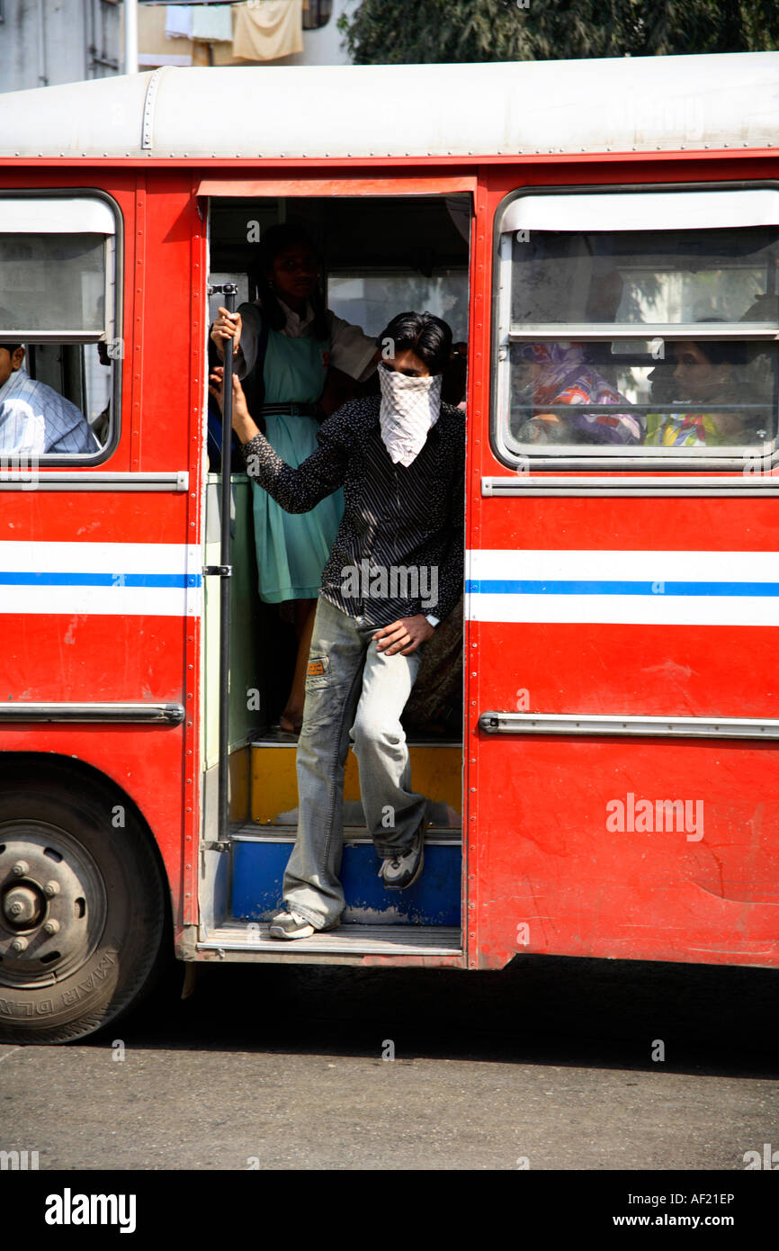 Man on bus with face mask shielding himself from traffic pollution ...