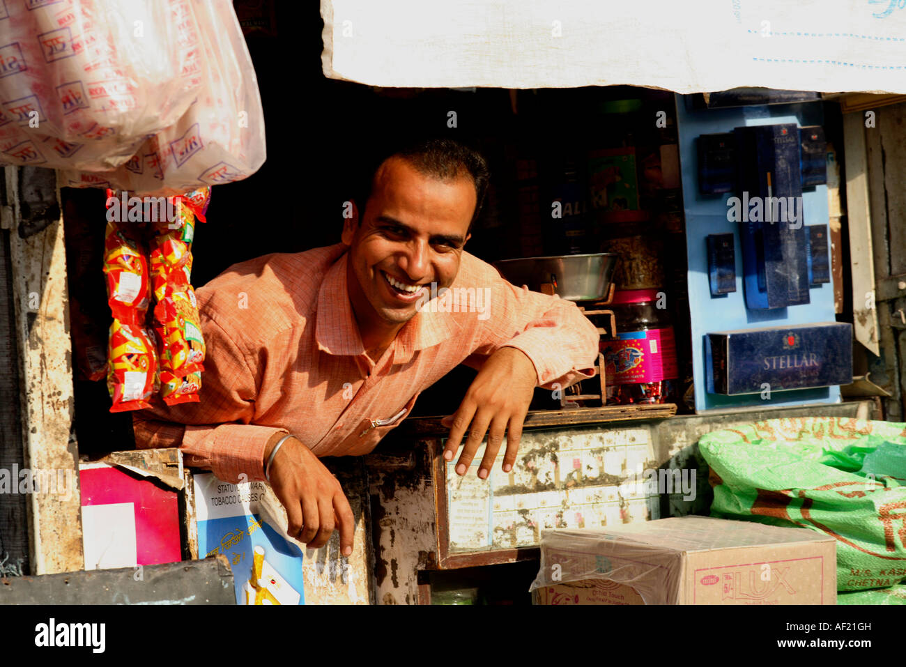 Indian Shop Trader leaning head from stall, Pune, India Stock Photo - Alamy