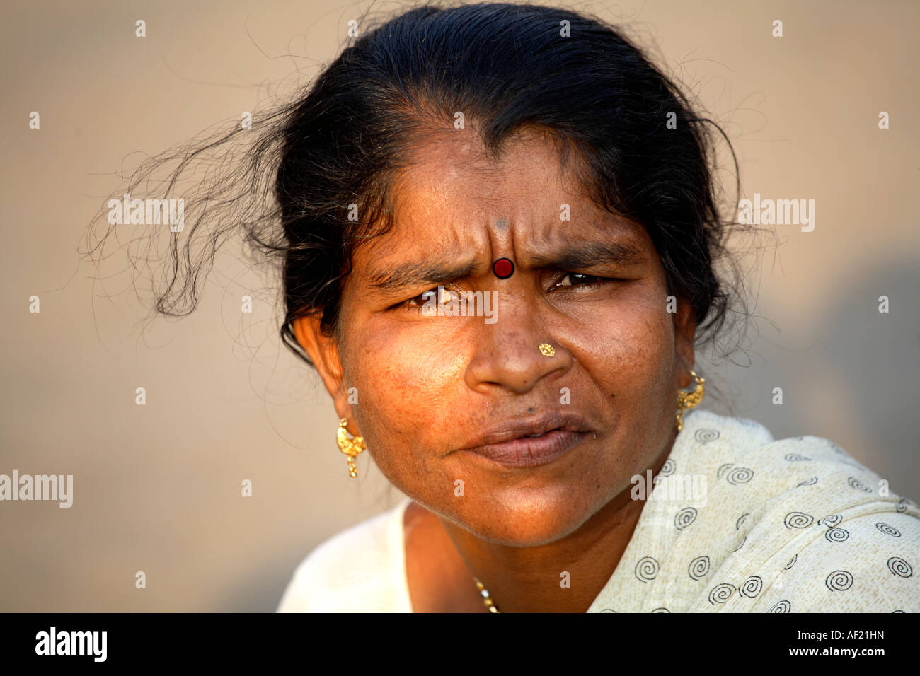Close up of frowning Indian female posing for photograph at Railway ...