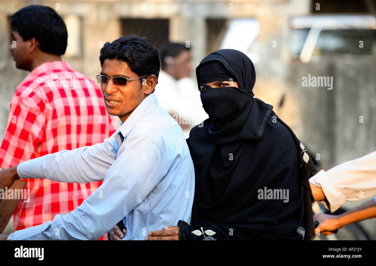 Muslim Indian female wearing niqab riding on back of motorbike, Pune ...