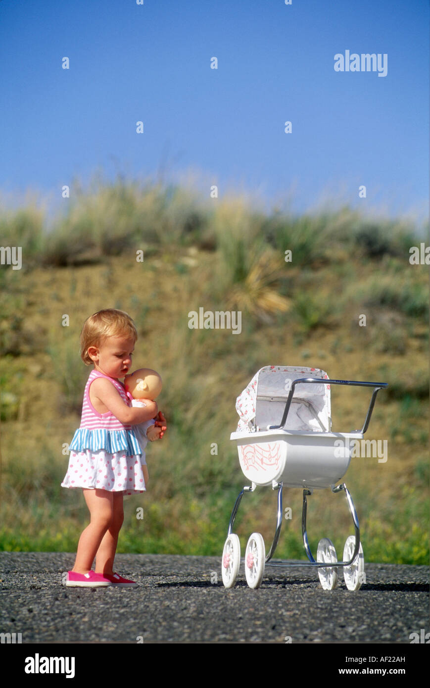 Little girl with baby carriage Stock Photo - Alamy