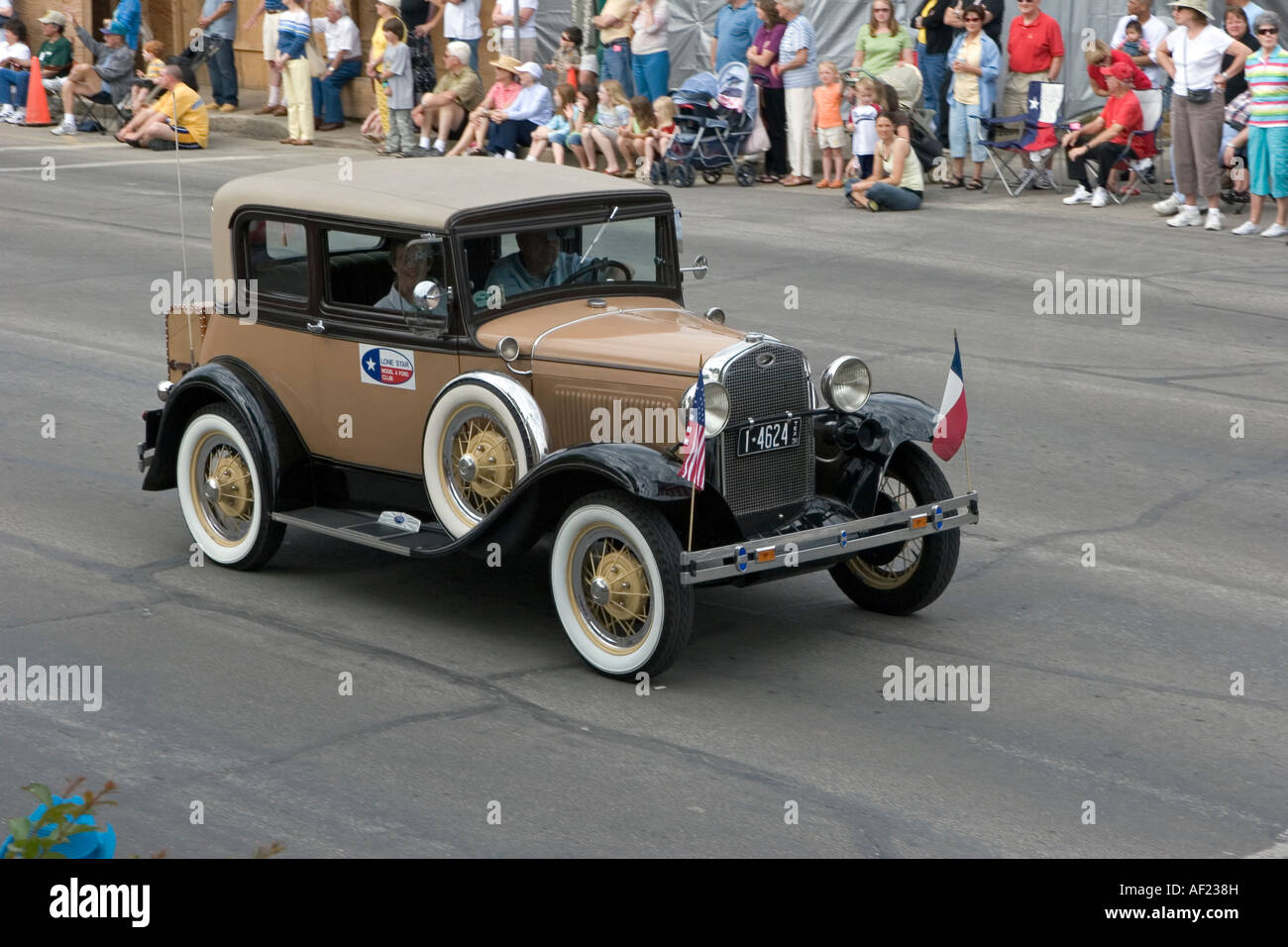 Brown Ford Model A driving in street festival parade Stock Photo - Alamy