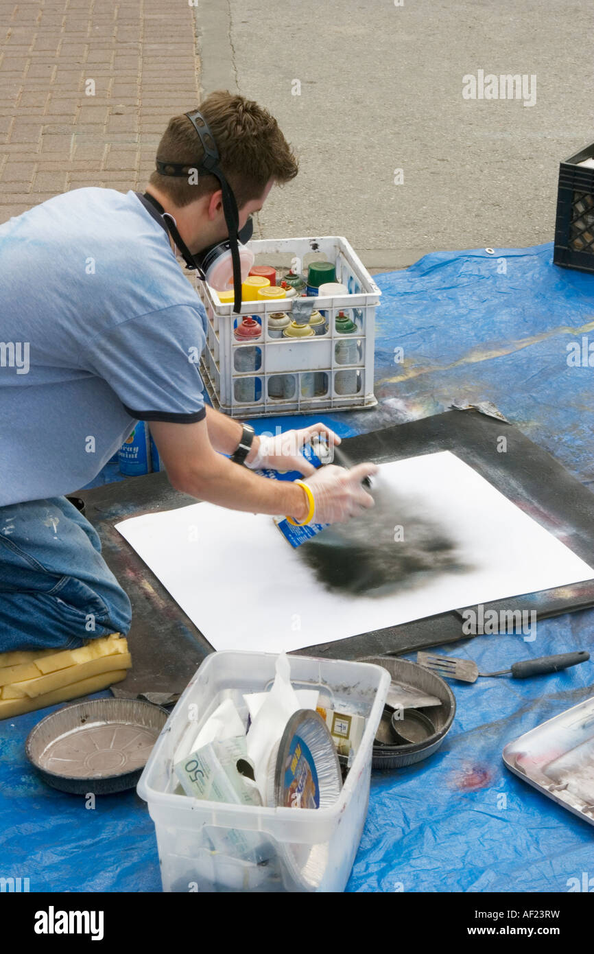 Spray paint artist working at an arts and crafts fair Stock Photo - Alamy