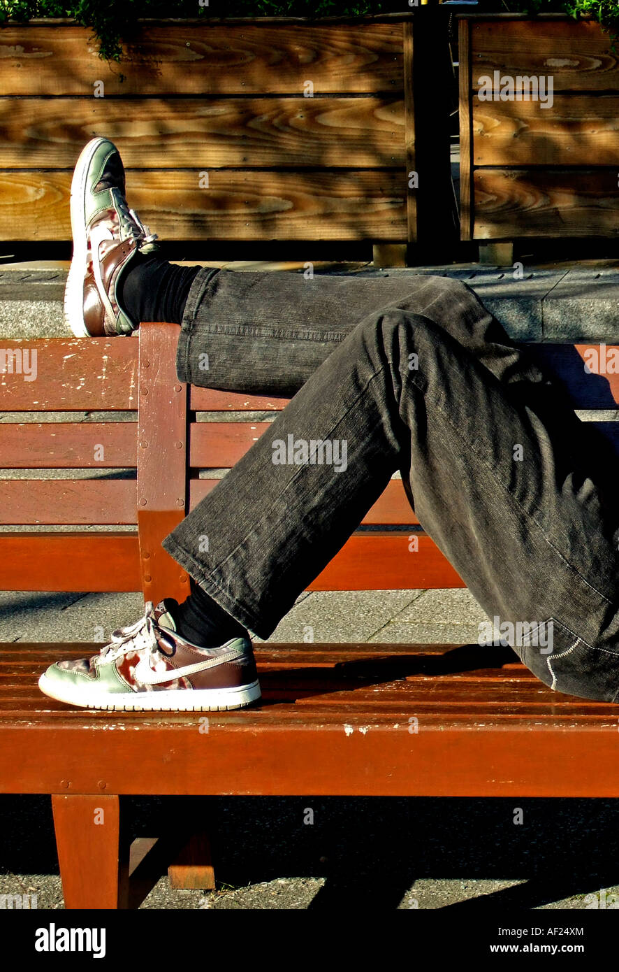 man lounging on bench Stock Photo - Alamy