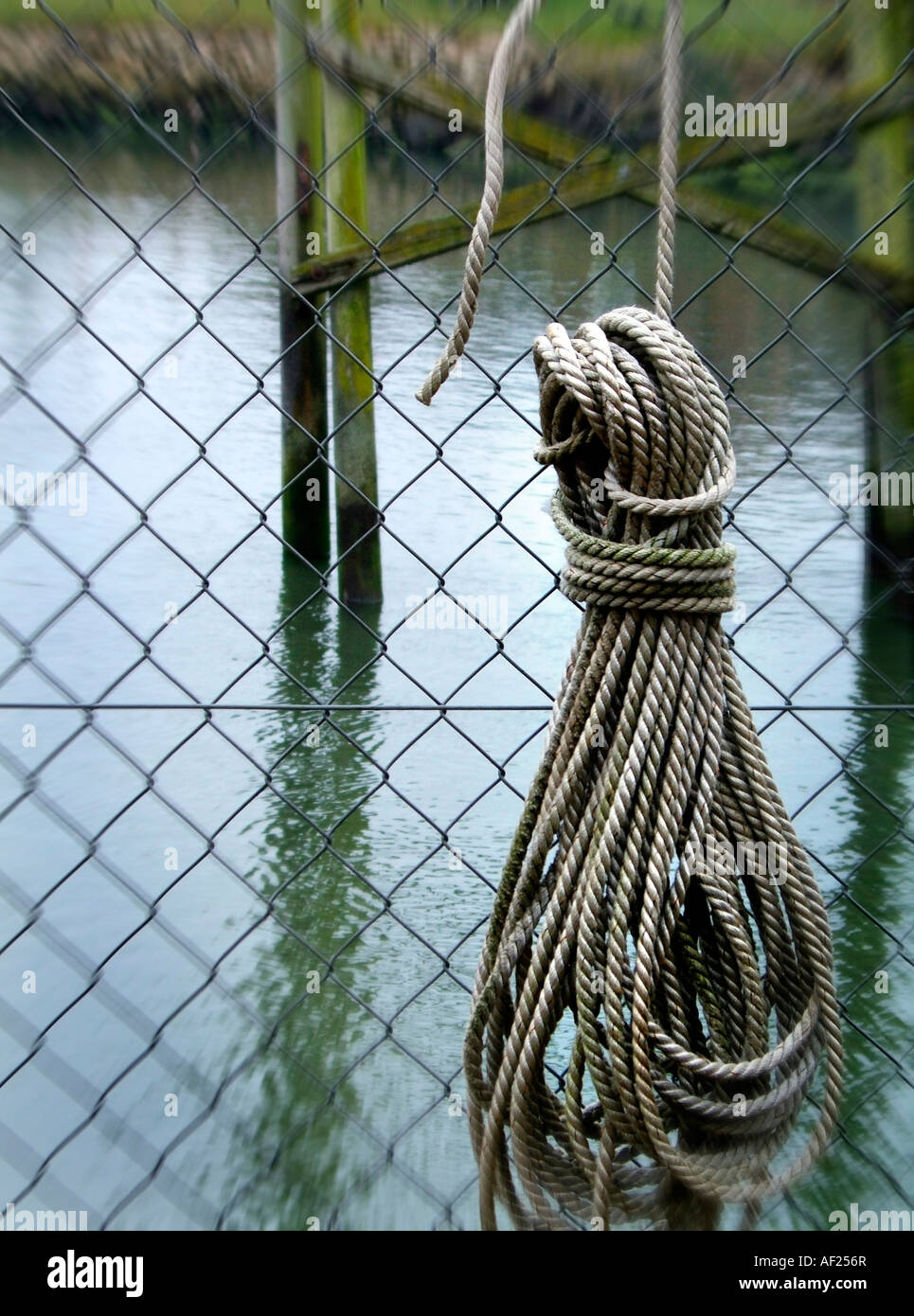 coil of rope hanging on fence Stock Photo - Alamy