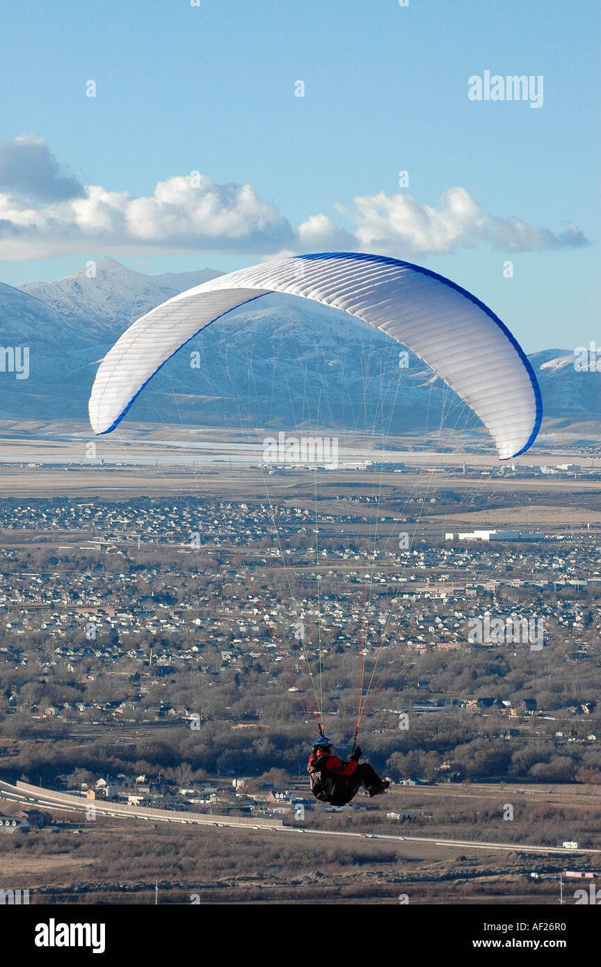 Pilot flying white and blue para glider against a backdrop of the Salt ...