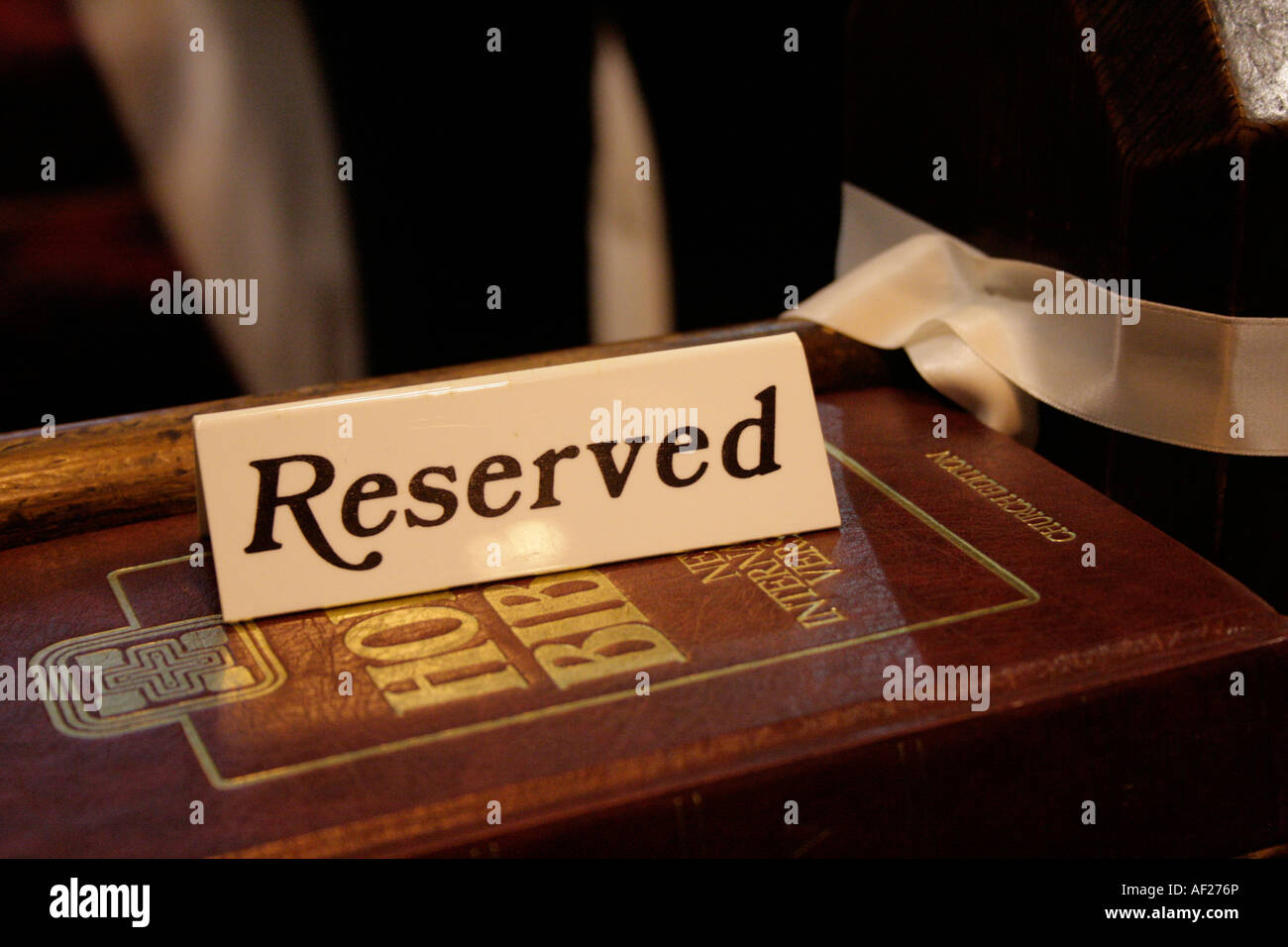 Reserved sign on top of a bible in church Stock Photo - Alamy