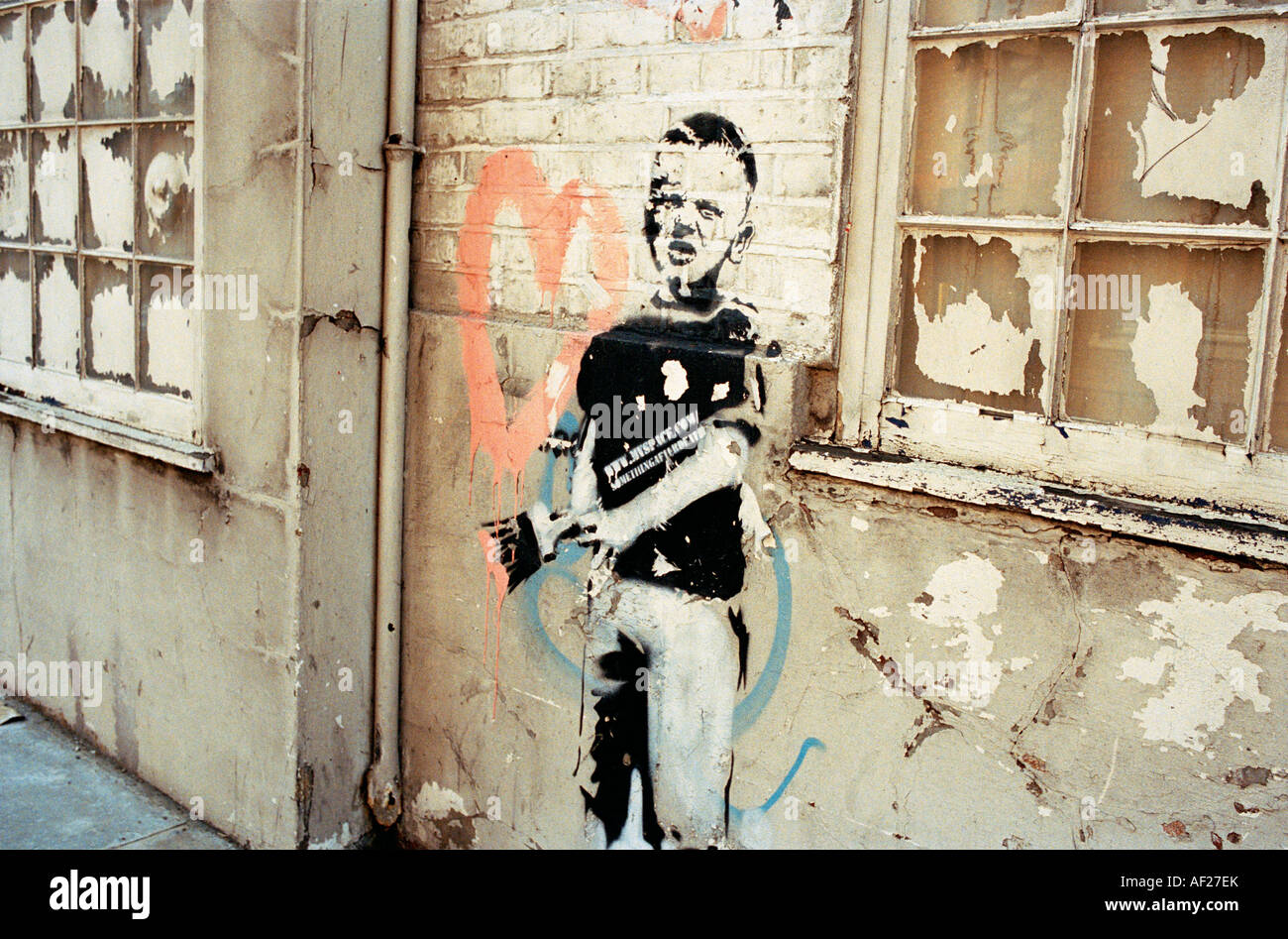 Stenciled street art by graffiti artist Banksy in Islington, London ...