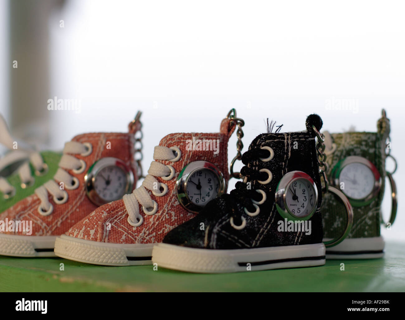 Street market display of key chain clock boots Stock Photo - Alamy