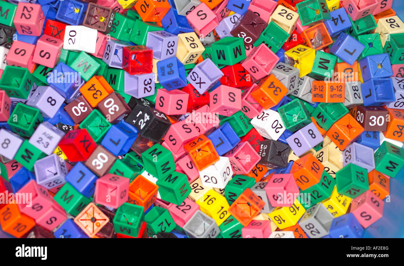 Size tags for clothing in a clothes shop Stock Photo - Alamy