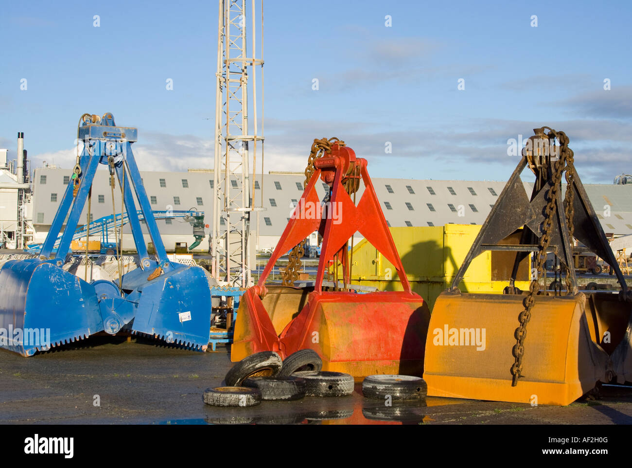 Trio of brightly coloured crane 'grab-buckets'. 2007 Stock Photo - Alamy
