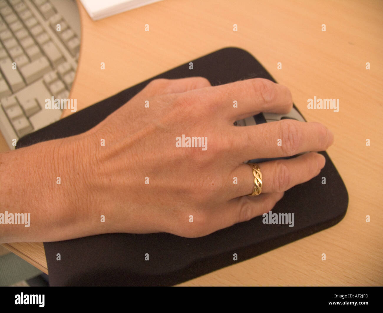 STUDIO STILL LIFE Image of a womans hand using a wireless mouse at the ...