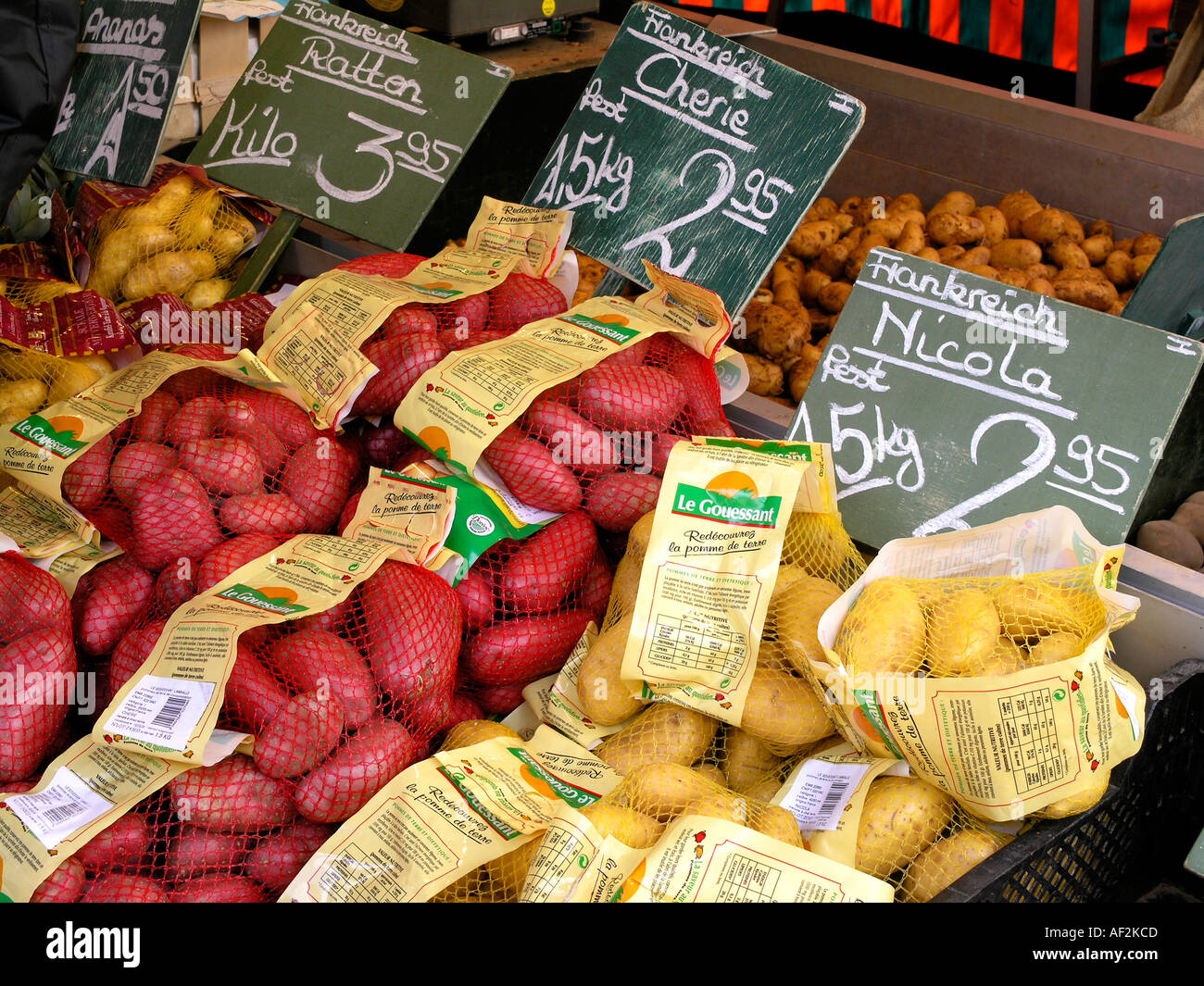 Different kinds of bagged potatoes for sale at local market Stock Photo ...