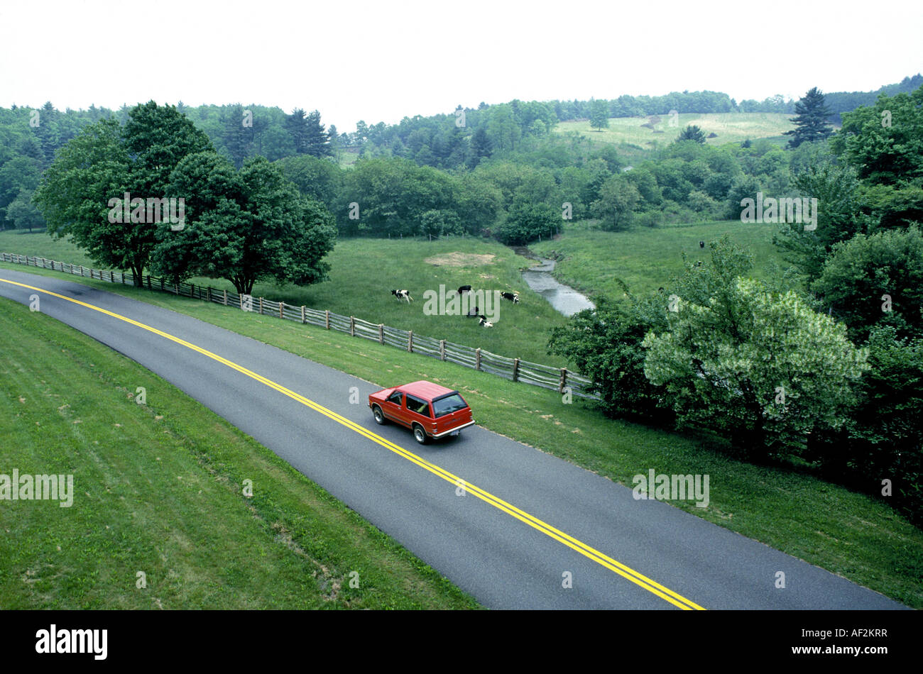 An automobile navigates the beautiful countryside along the Blue Ridge ...