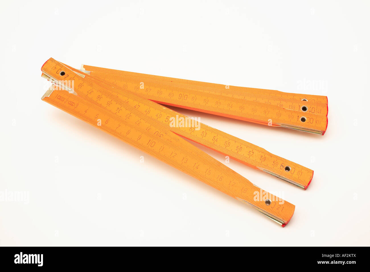 a yellow metre rule on a white surface Stock Photo - Alamy