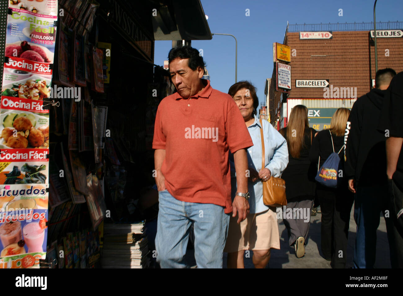 Hispanic man walking by newsstand in downtown Los Angeles Stock Photo ...