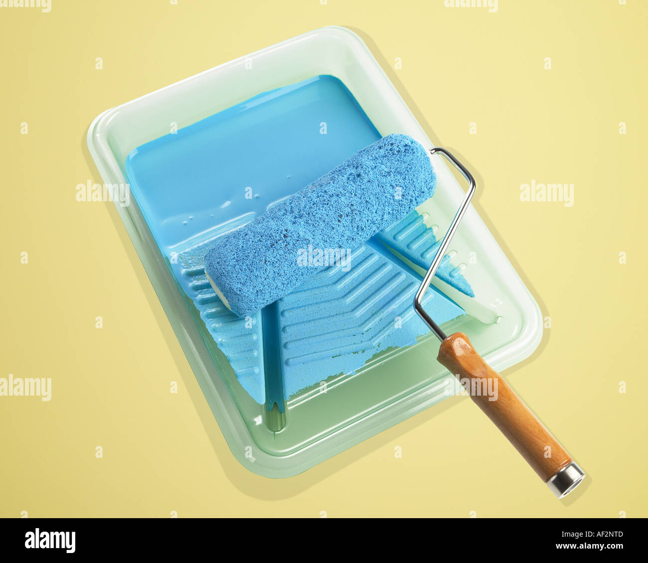 Red Rocket Stock Paint with roller in tray on color background with ...