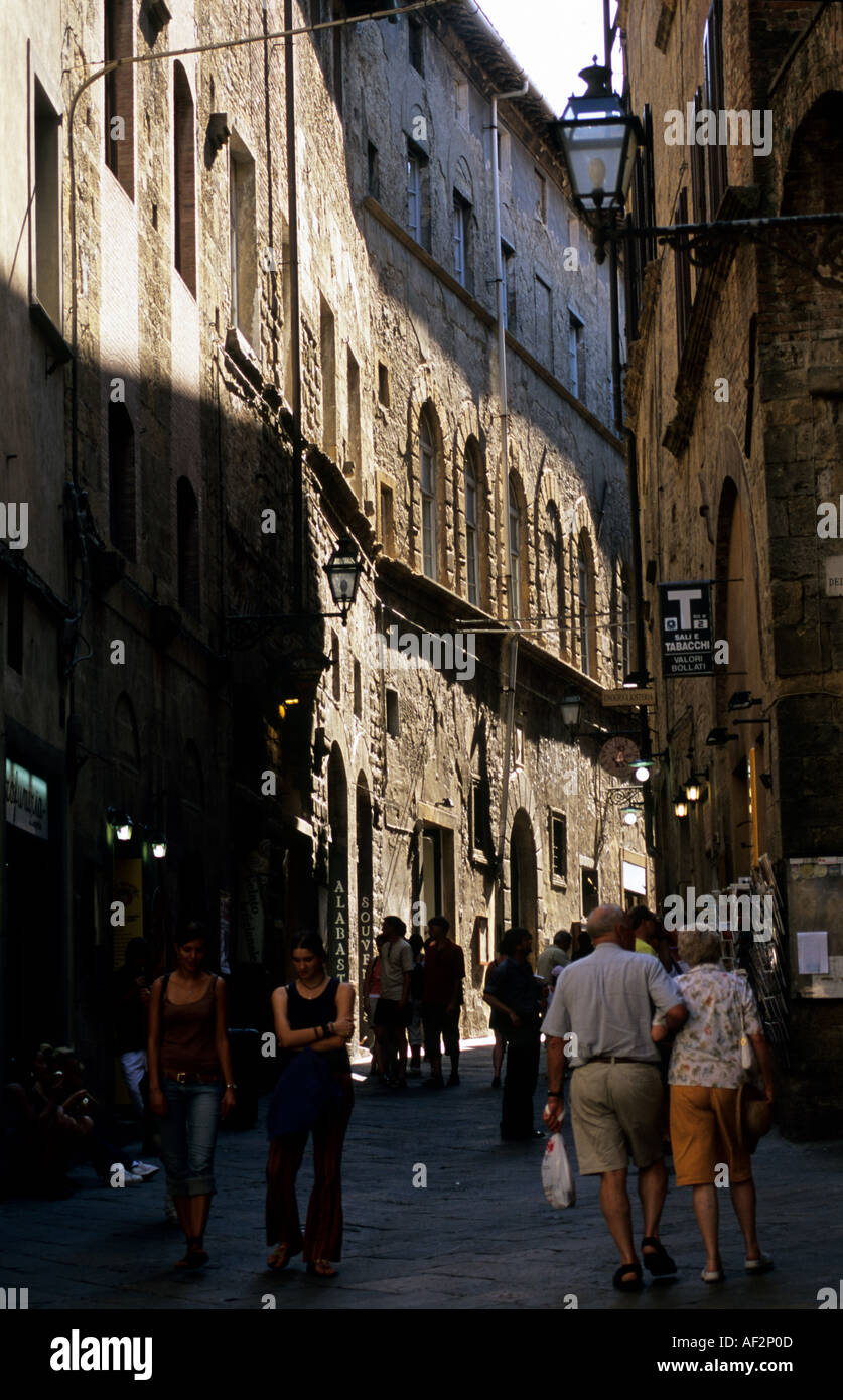 Volterra street in sunset and tourists Stock Photo - Alamy