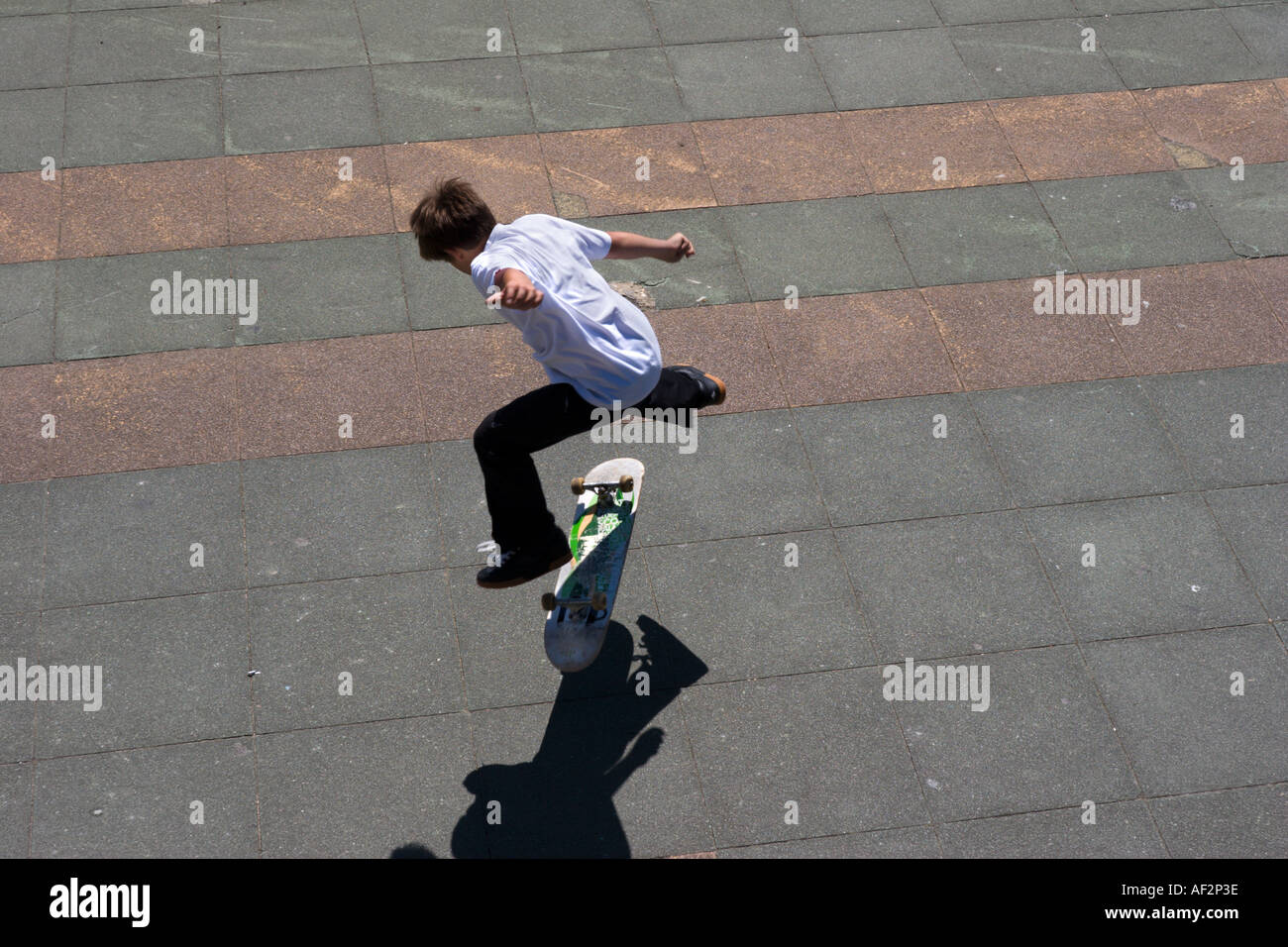 Kids doing trick jumps on their skateboards at Brighton Sussex England ...