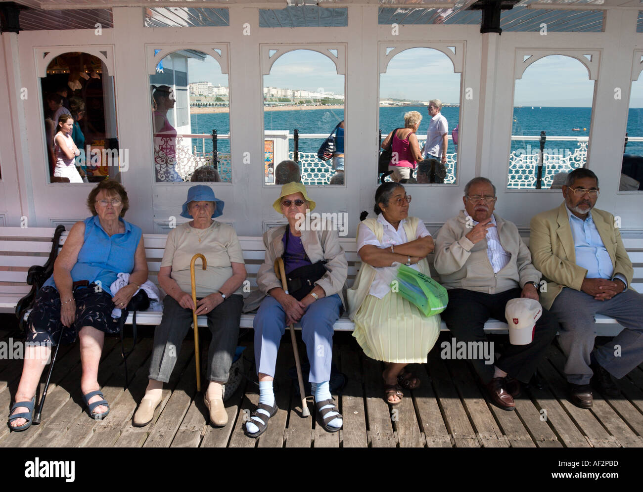 Elderly infirm disabled outing sitting bench pier hi-res stock ...
